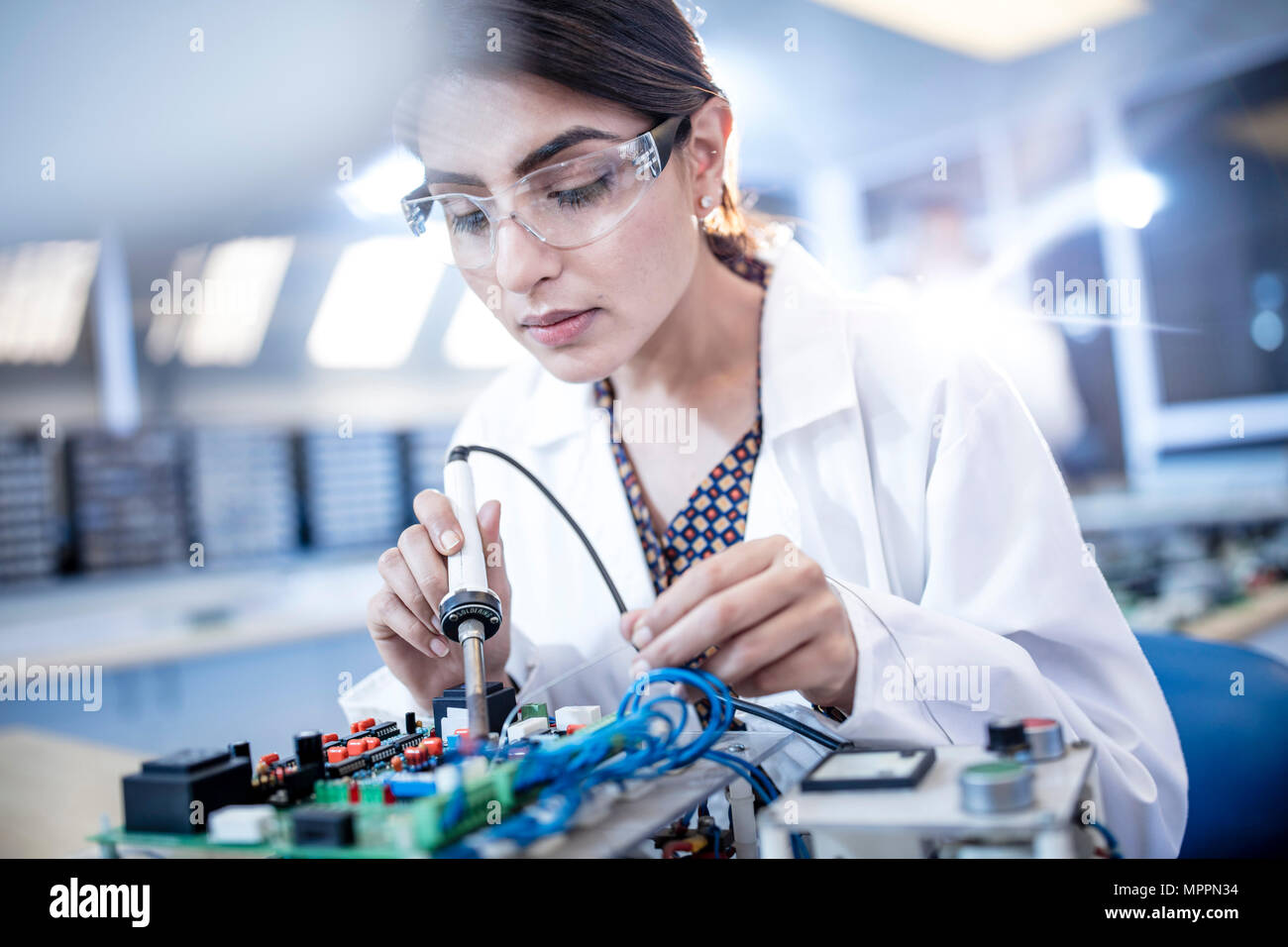 Female technician working on motherboard Stock Photo - Alamy