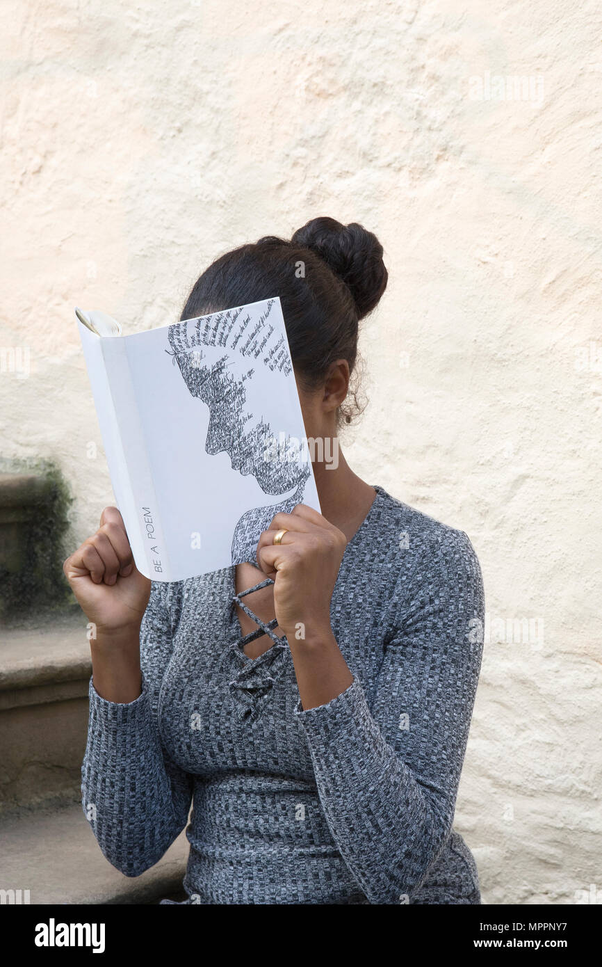 Girl Hiding Face With Book