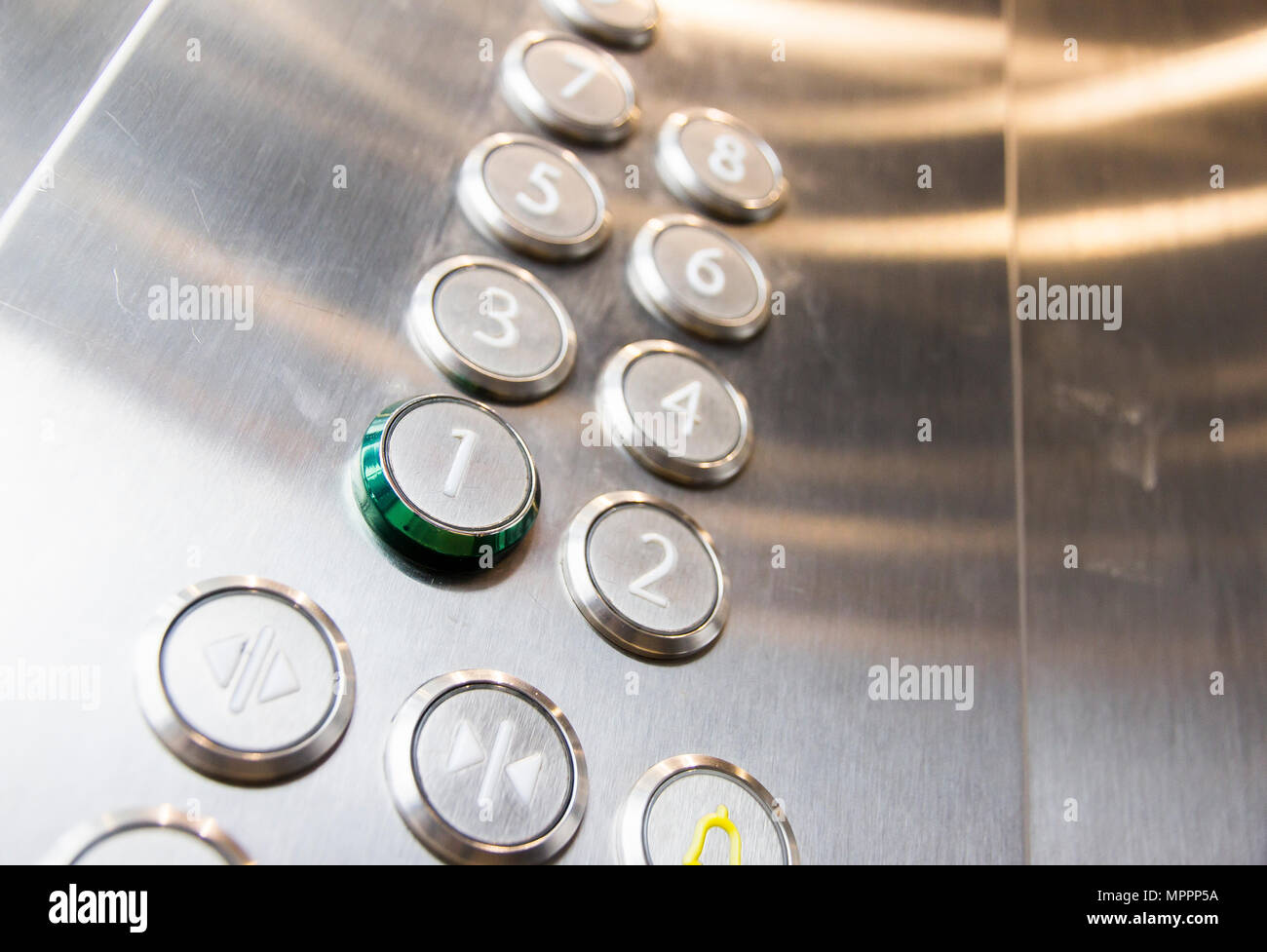 Button lift metal modern business center close-up Stock Photo - Alamy