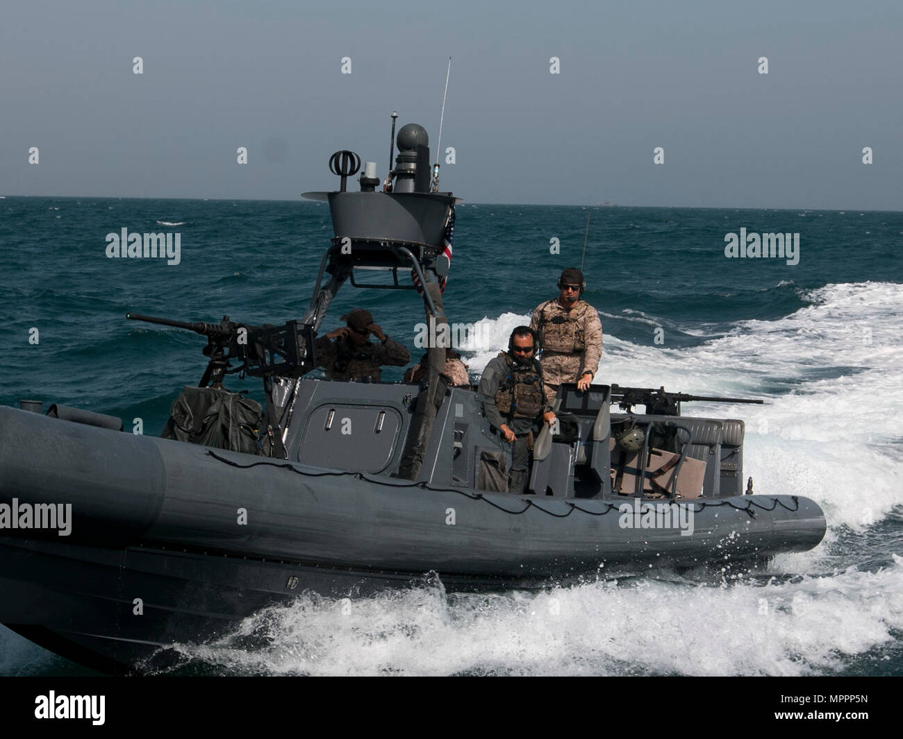 Members of the Navy's Special Boat Team ride up to pick up the Soldiers ...