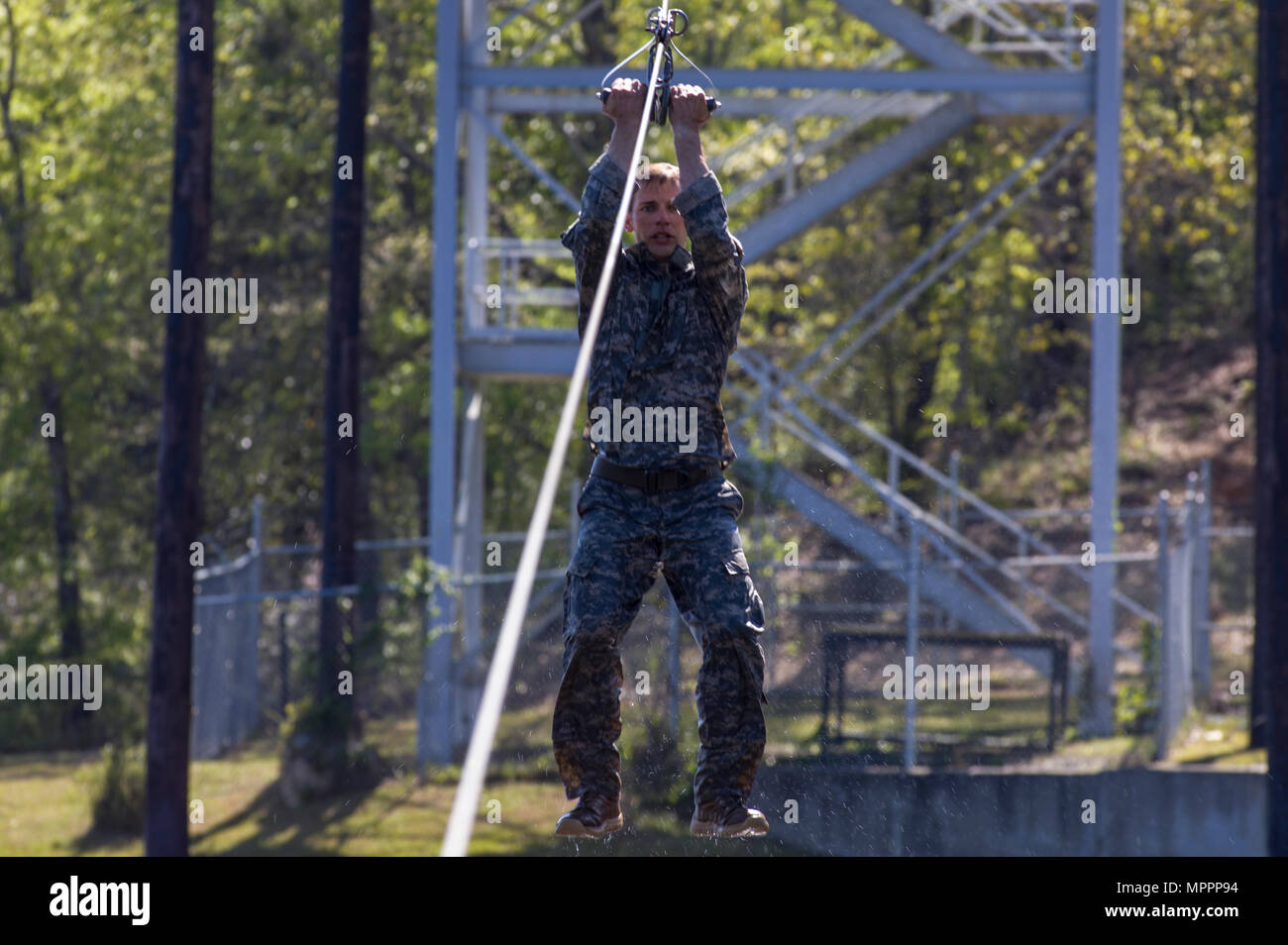 A U.S. Army Ranger performs the "slide for life" zipline at the Combat ...