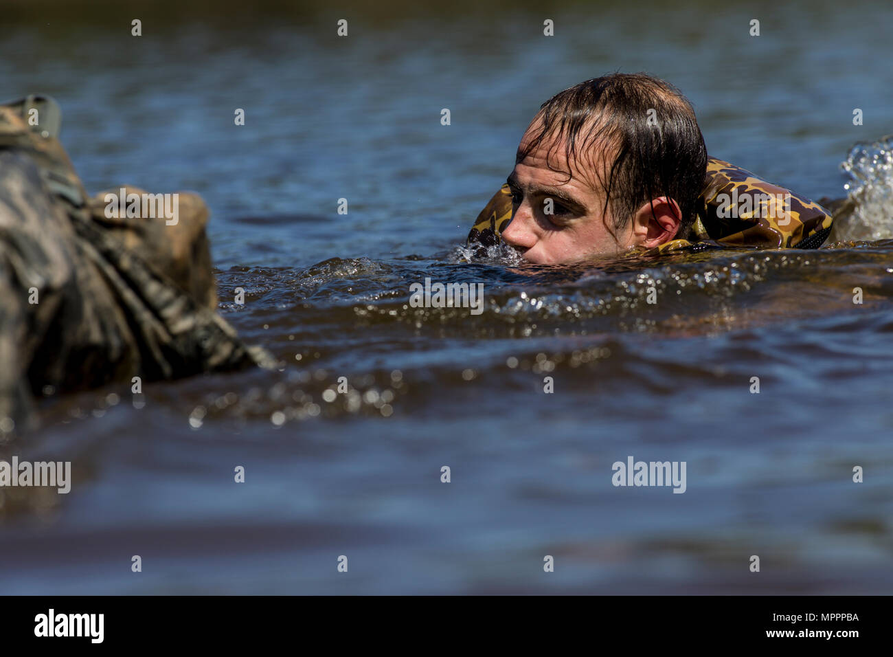 A U.S. Army Ranger swims ashore to perform the Combat Water Survival ...