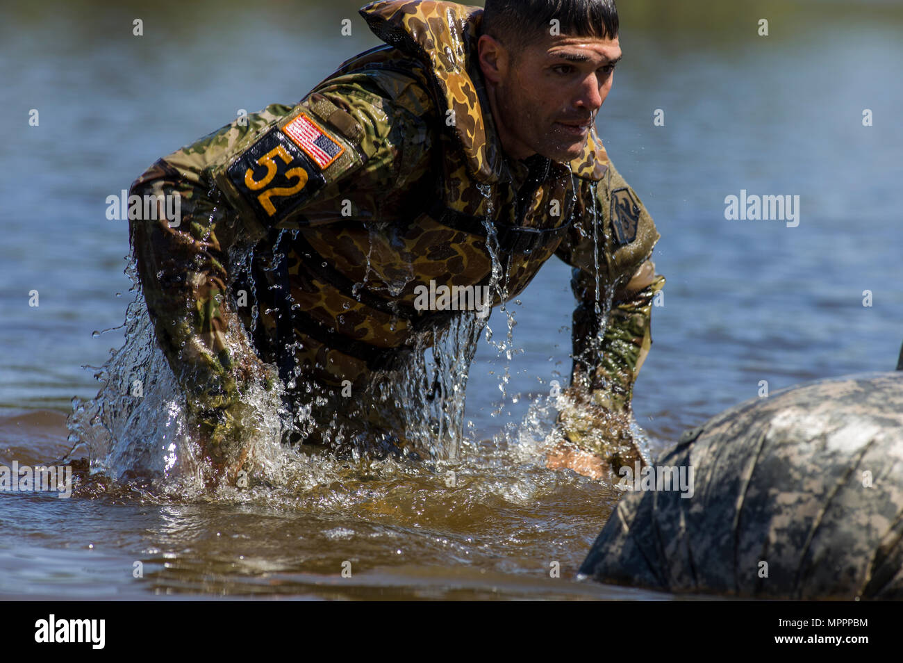 U.S. Army Ranger Capt. Timothy Cox, 3rd Chemical Brigade, walks ashore ...