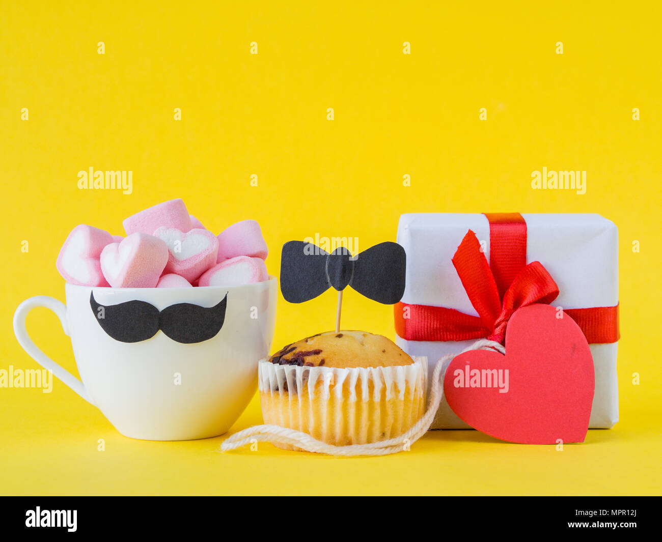 Father's day concept. DAD message with red rose and gift on yellow ...