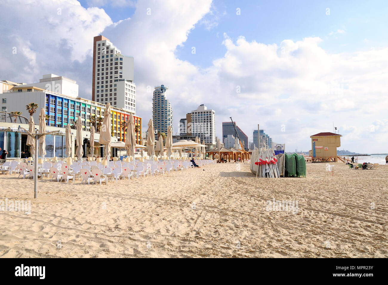 View to Tel Aviv urban beach with plastic chairs of open air restaurant ...