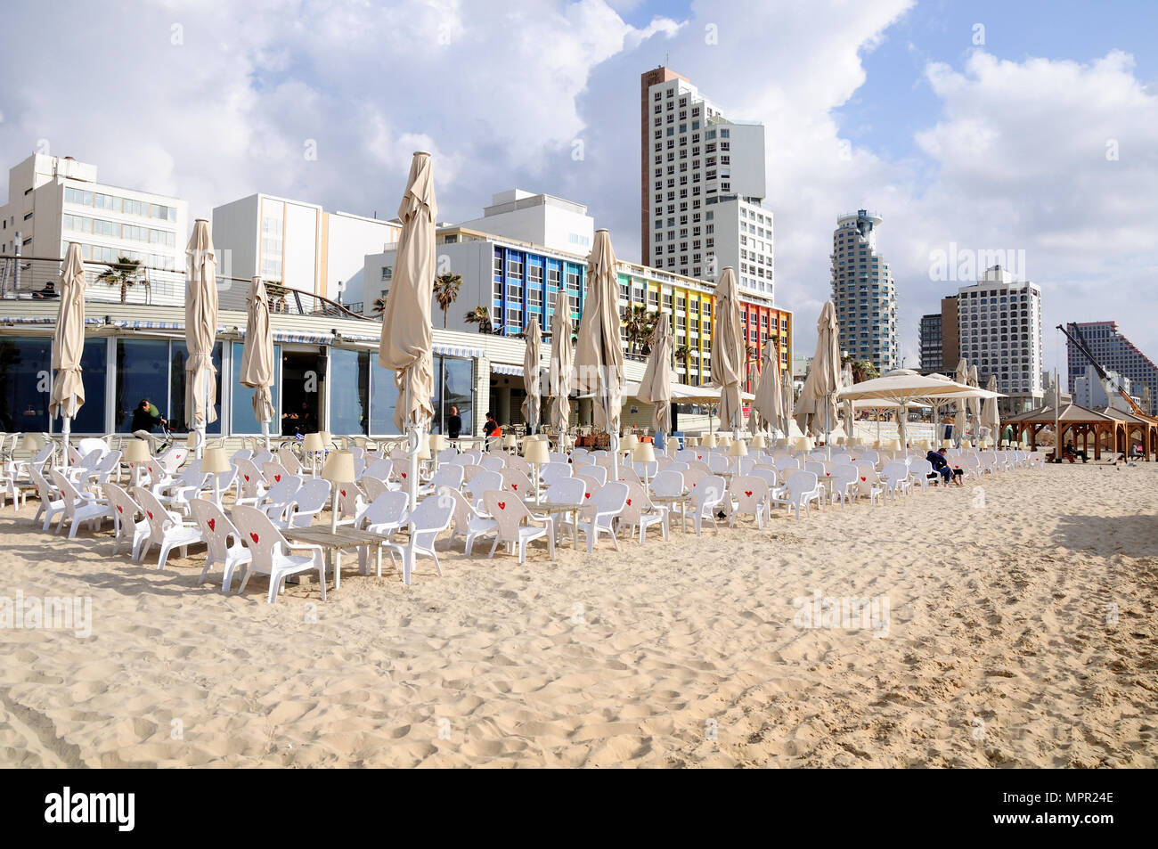 View to Tel Aviv urban beach with plastic chairs of open air restaurant ...