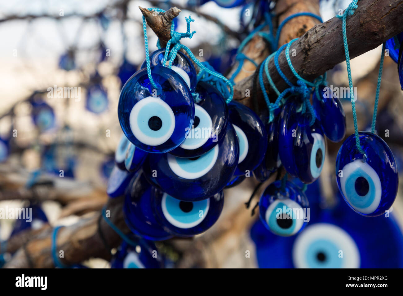 blue beads for good luck hanging on a tree Stock Photo - Alamy