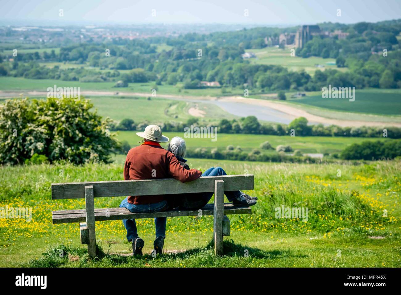 A couple on a bench looking across the Adur Valley towards Lancing ...