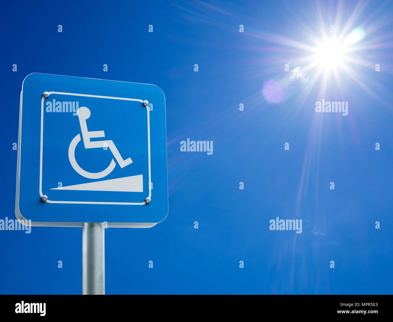 Disabled parking space and wheelchair way sign and symbols on a pole ...