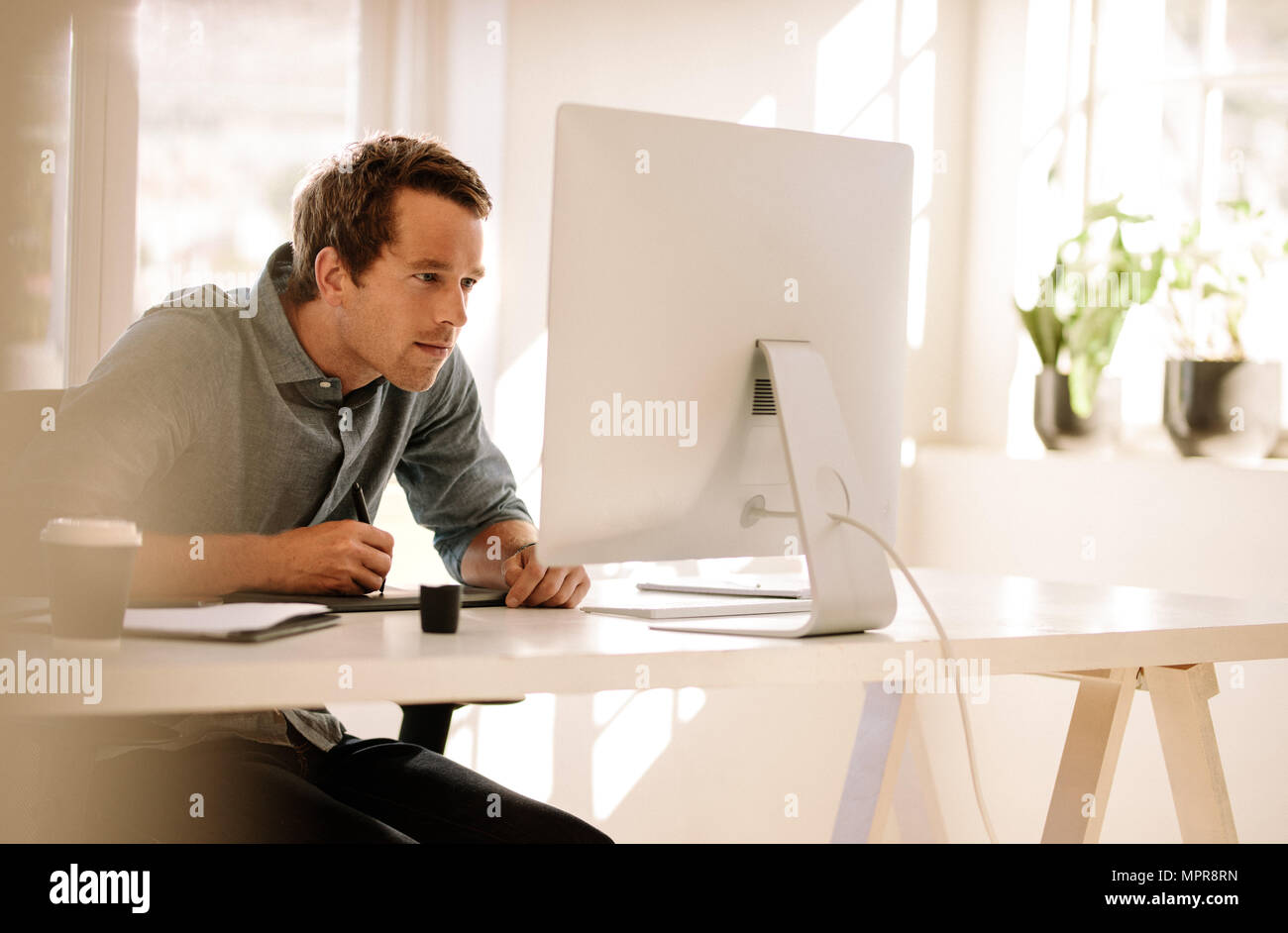 Looking closely at a computer screen hi-res stock photography and ...