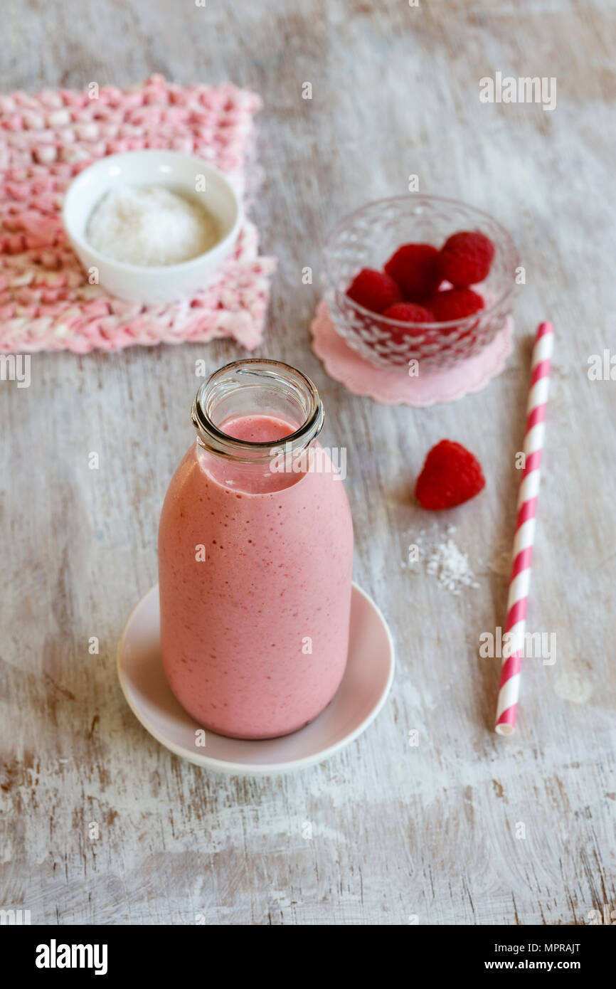 Glass bottle of raspberry smoothie Stock Photo - Alamy