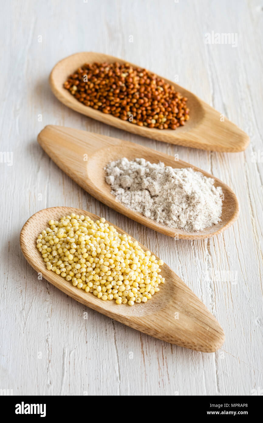 Spoons of Golden and brown millet and millet meal Stock Photo - Alamy
