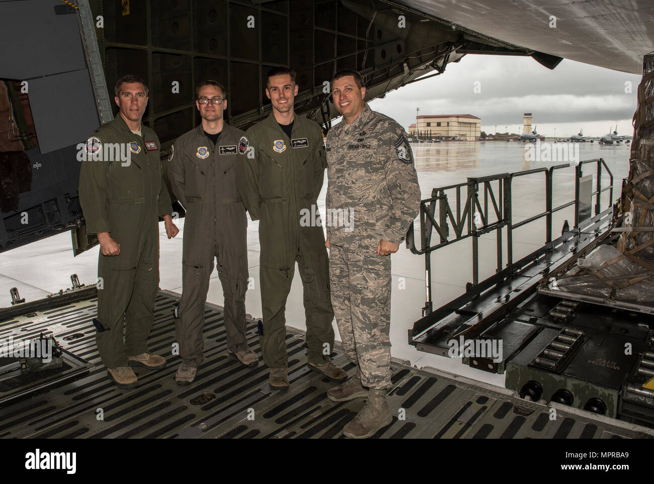 Aircrew from the 22nd Airlift Squadron pose at the aft cargo door of a ...