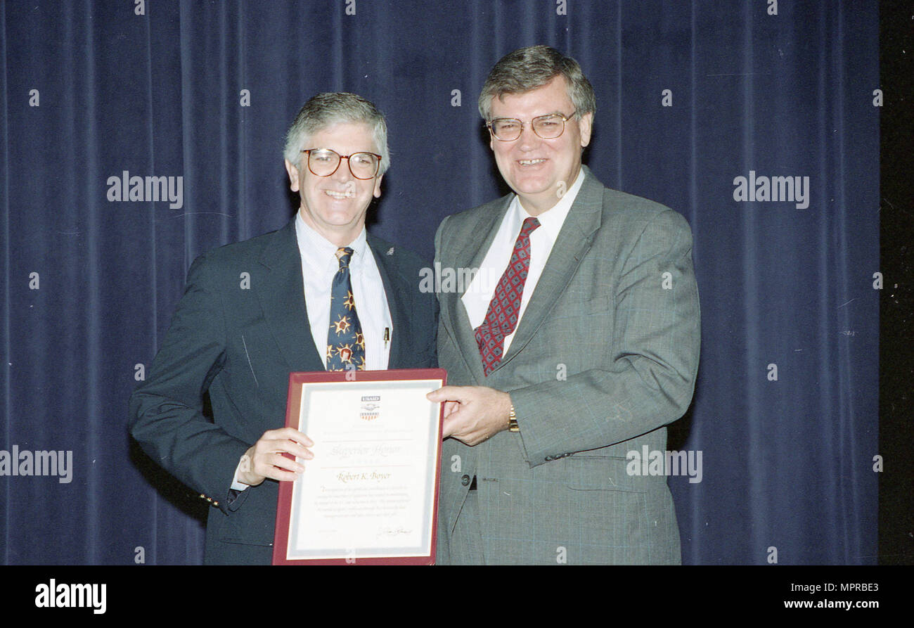 Two men holding an awards certificate Stock Photo - Alamy