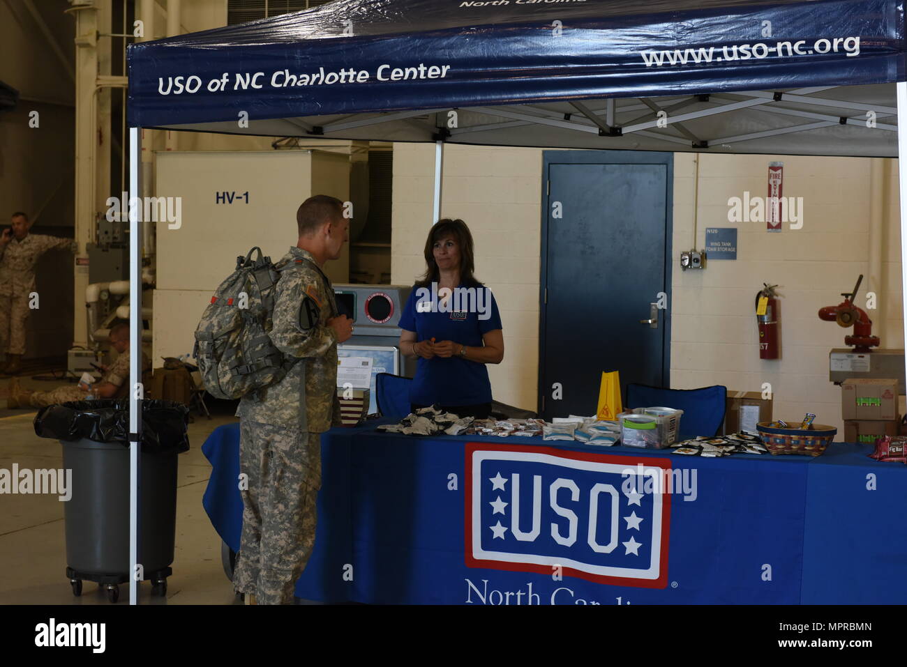 A U.S. Army Soldier talks with North Carolina USO employee Julie Milani ...