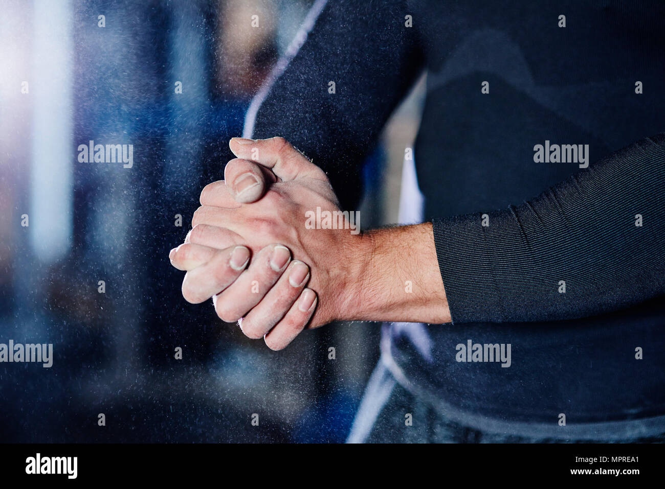 Athlete applying chalk on his hands Stock Photo - Alamy
