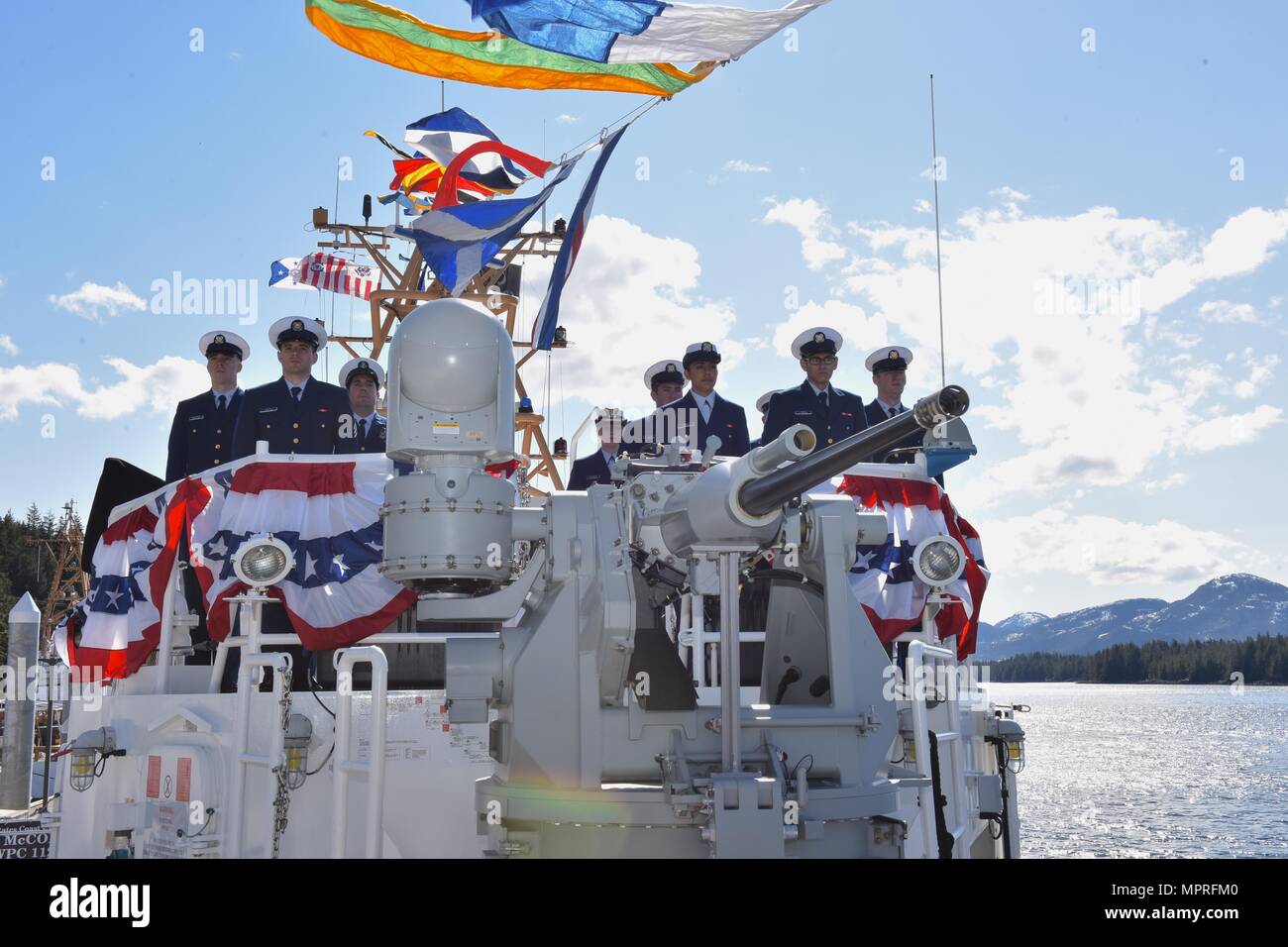 The crew of the Coast Guard Cutter John McCormick stands proud facing ...