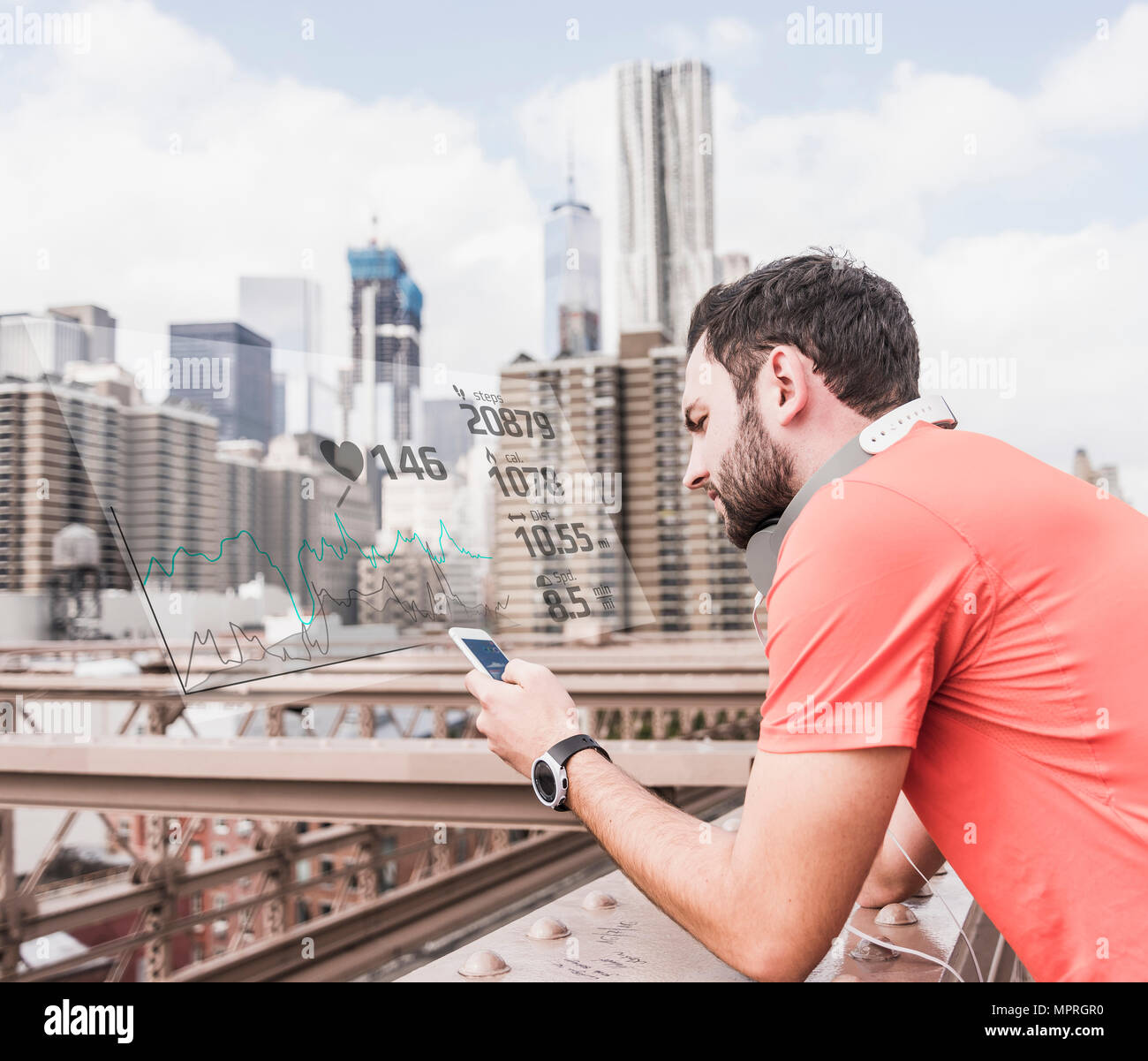 USA, New York City, sportive young man having a break checking data ...