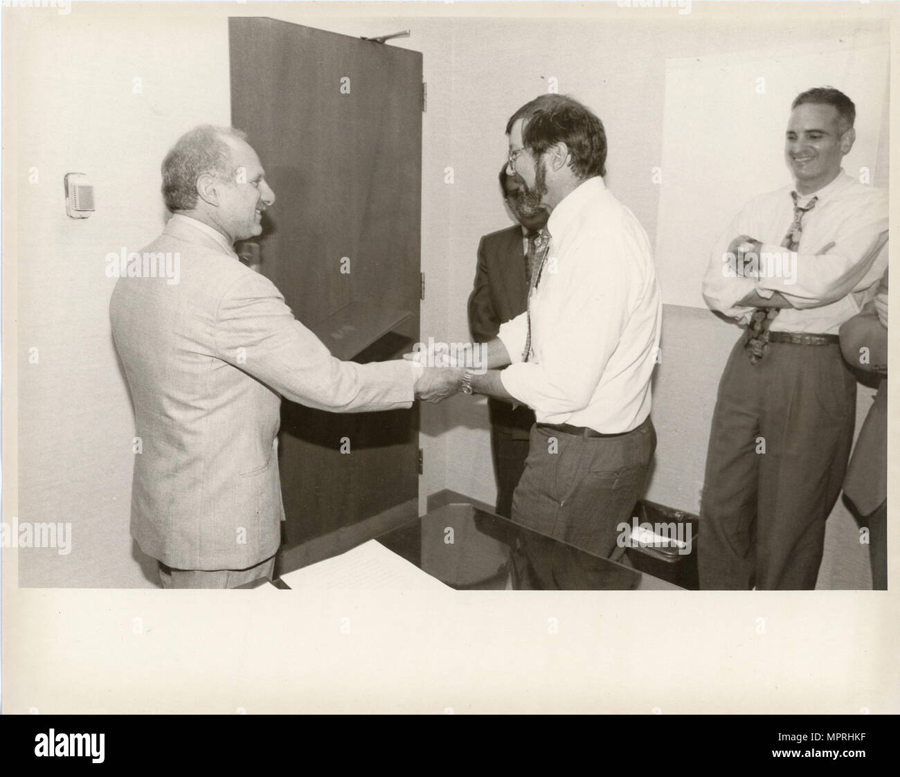 Admin. Atwood presenting general awards - Handshake after meeting Stock ...