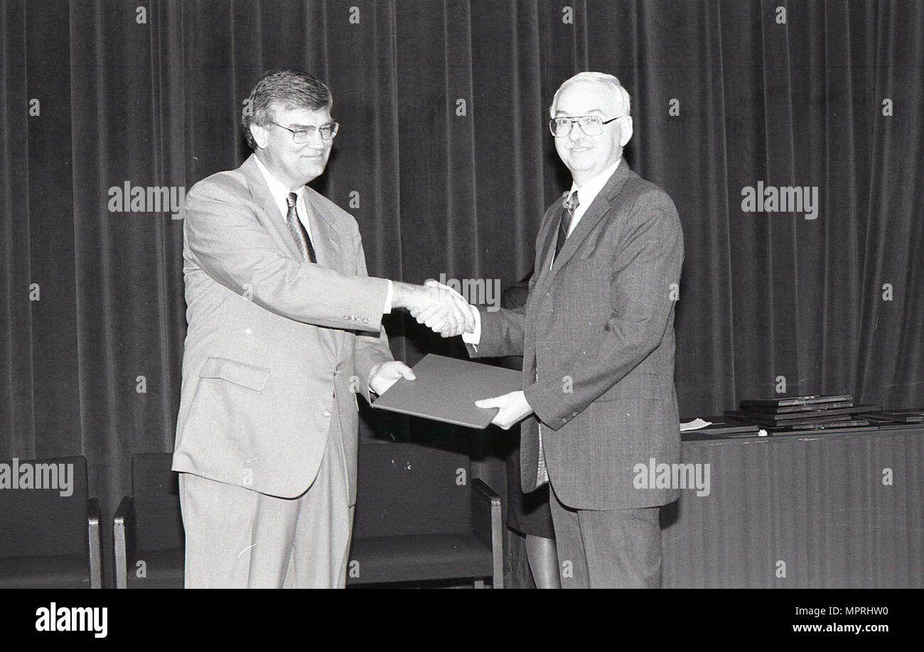 Admin. Atwood presenting general awards - Man receiving award on stage ...