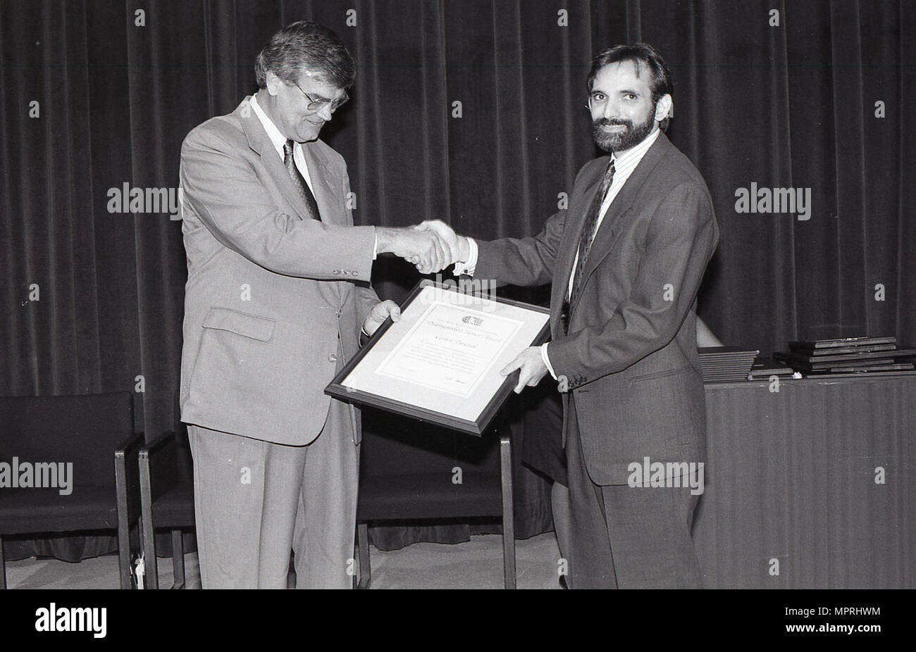 Admin. Atwood presenting general awards - Man receiving award on stage ...
