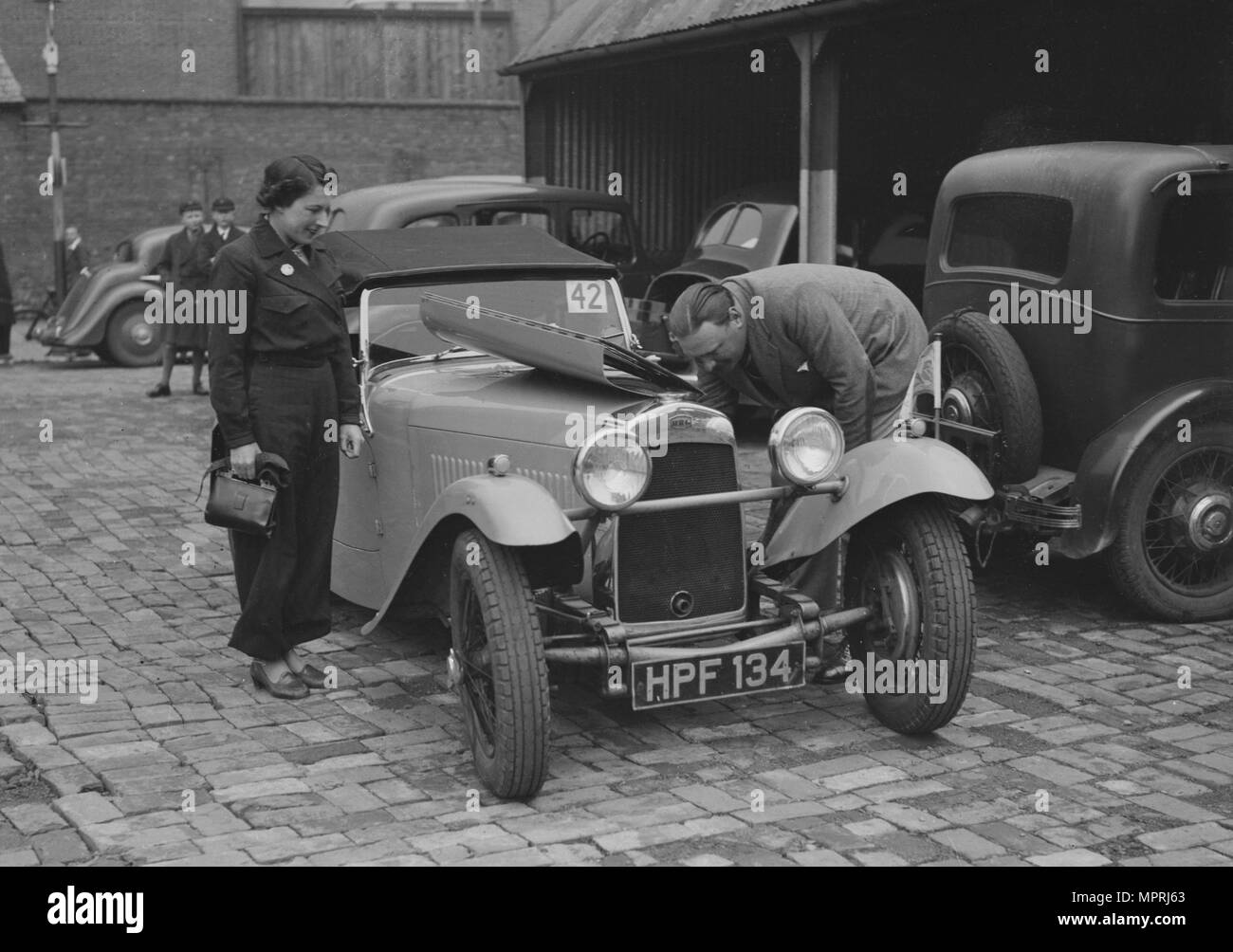 AES Curtis looking under the bonnet of his HRG at the RAC Rally, 1939 ...