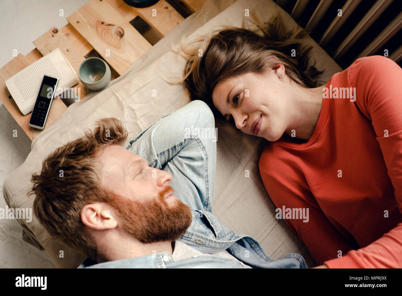 Happy couple at home talking and listening to each other Stock Photo ...