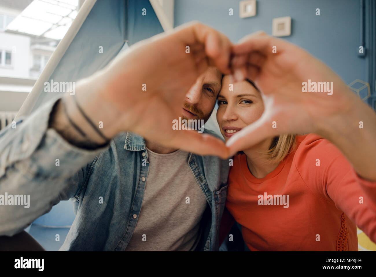 Happy couple at home camping ina tent in the livingroom Stock Photo - Alamy