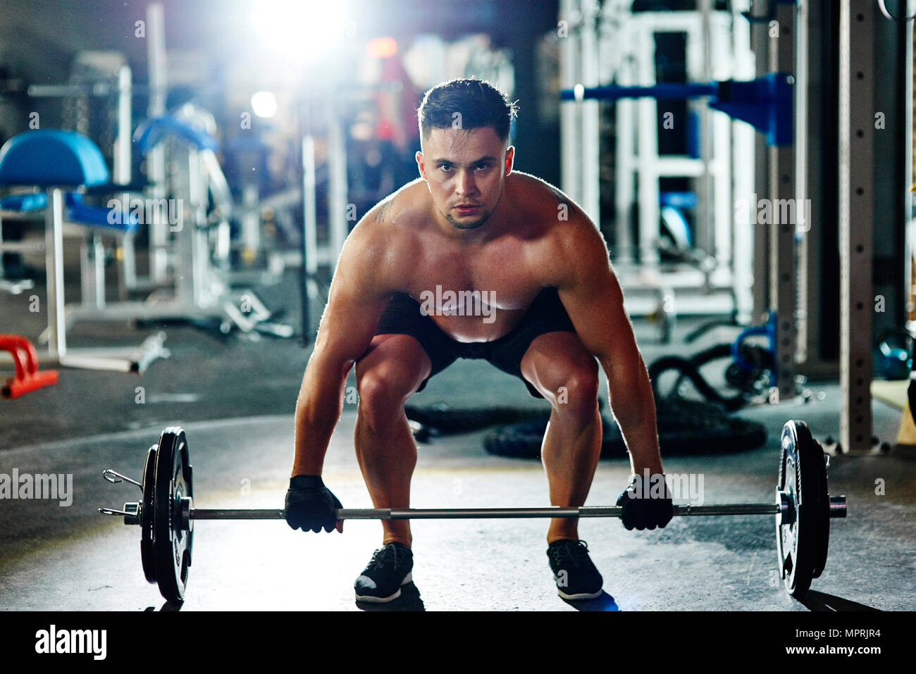 Man lifting barbell in gym Stock Photo - Alamy