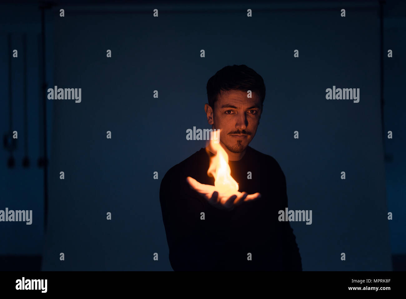 Portrait of magician with flame Stock Photo - Alamy