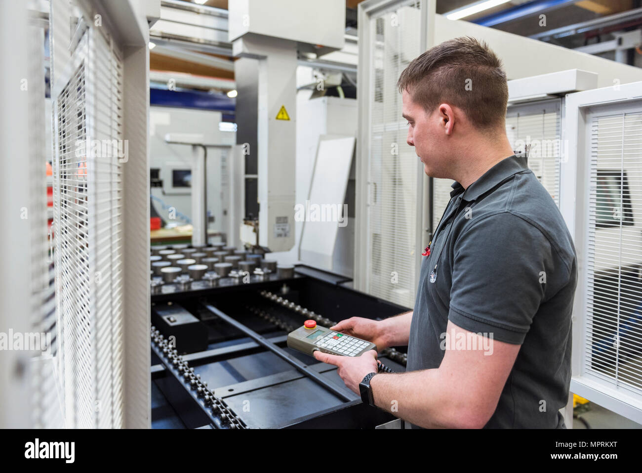 Man operating machine in factory Stock Photo - Alamy