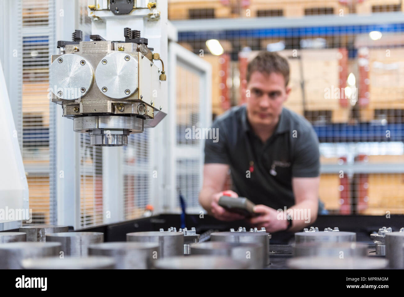 Man operating machine in factory Stock Photo - Alamy