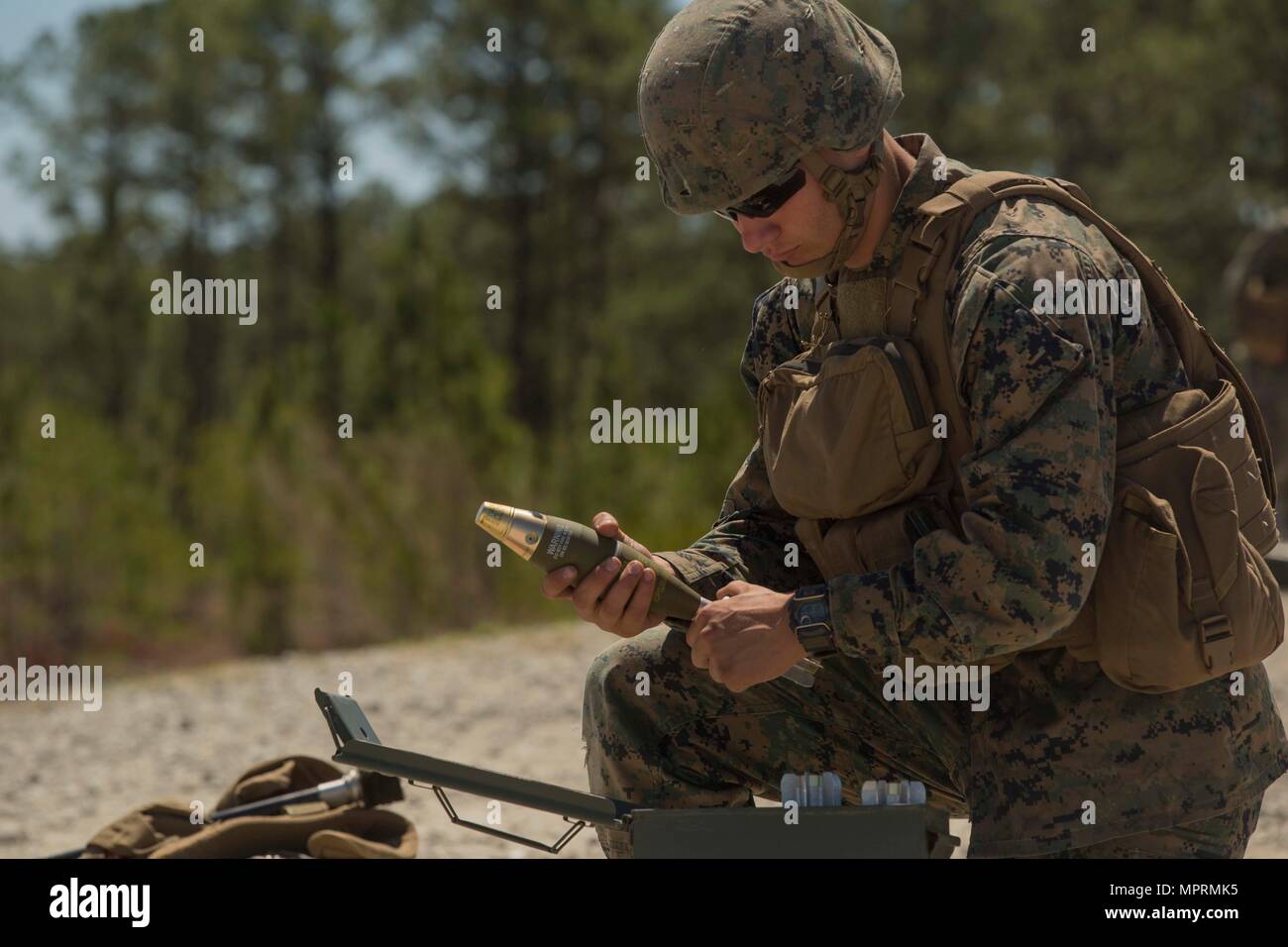 A Marine Mortarman prepares a 60mm mortar during a live-fire range at ...