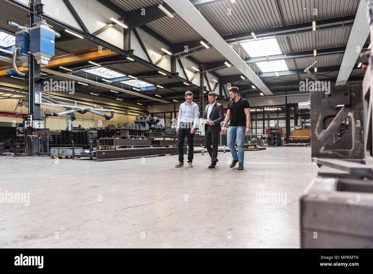 Three men walk hi-res stock photography and images - Alamy