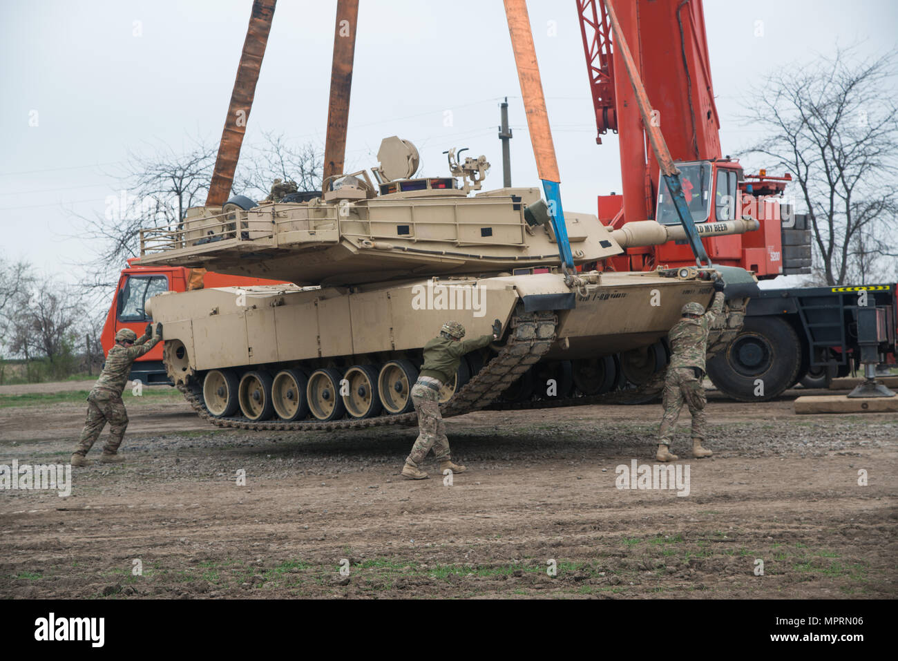 A M1A2 Abrams tank is off loaded from a transport vehicle near Smardan ...