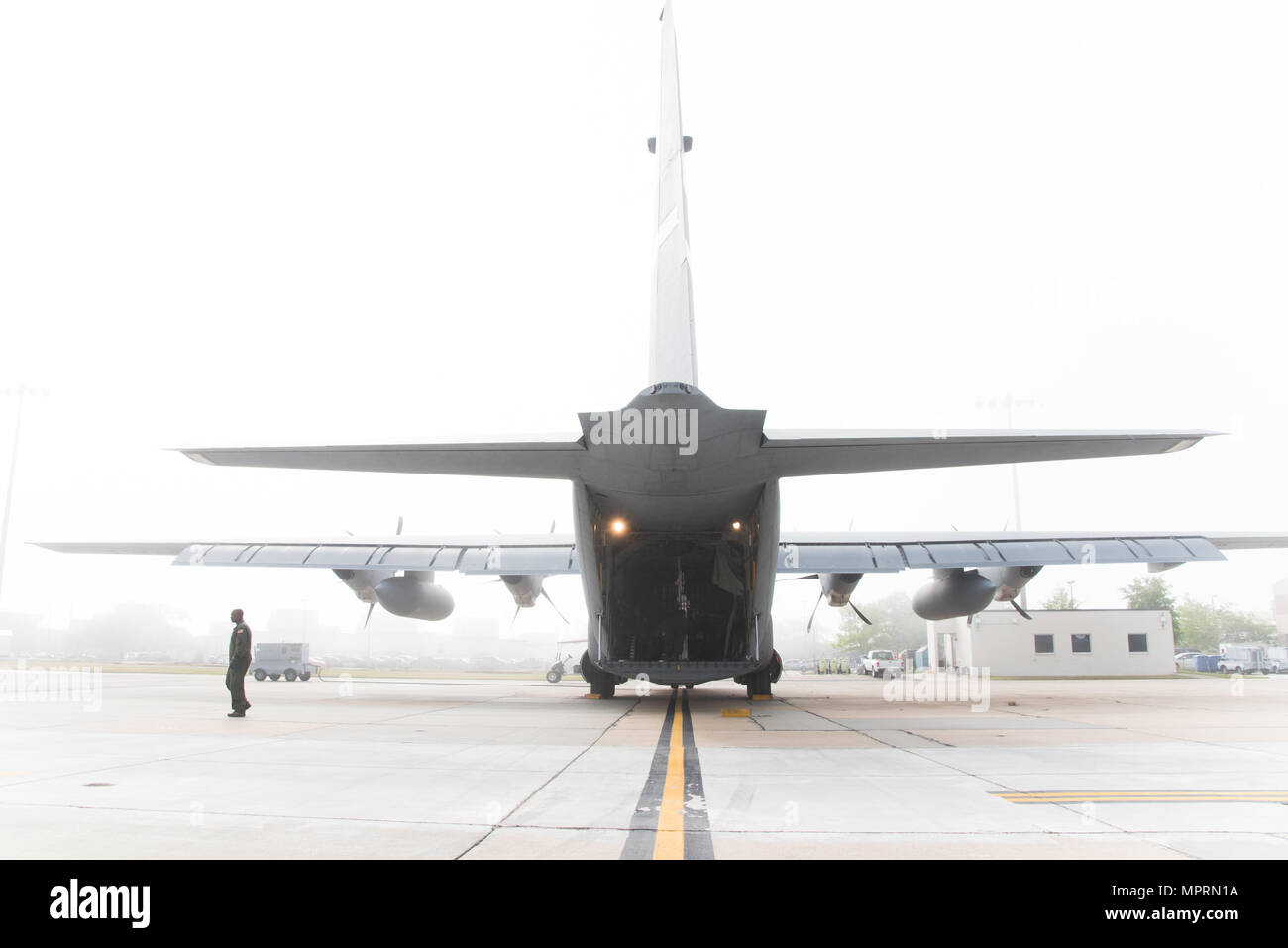 Master Sgt. Troy Bickham walks toward equipment to be loaded onto a WC ...