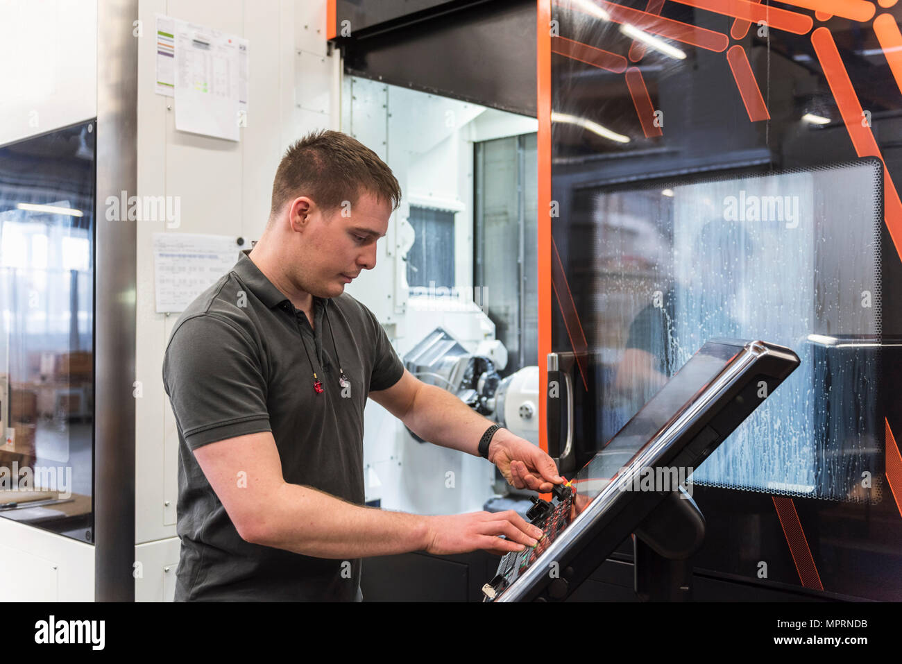 Man operating machine in factory Stock Photo - Alamy