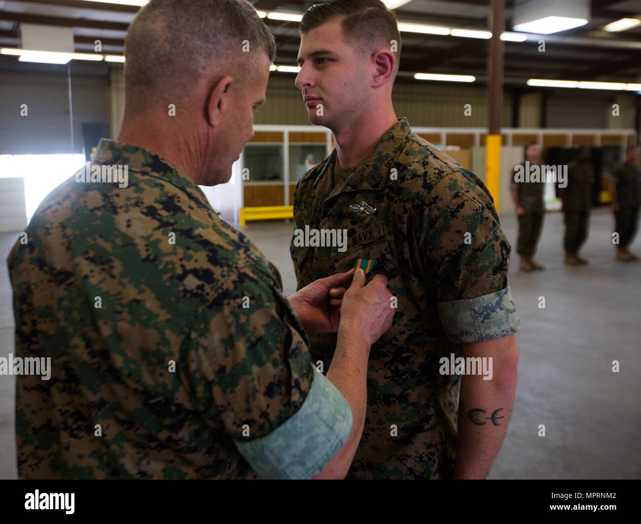 U.S. Navy Seaman Robert Thompson receives the Navy and Marine Corps ...