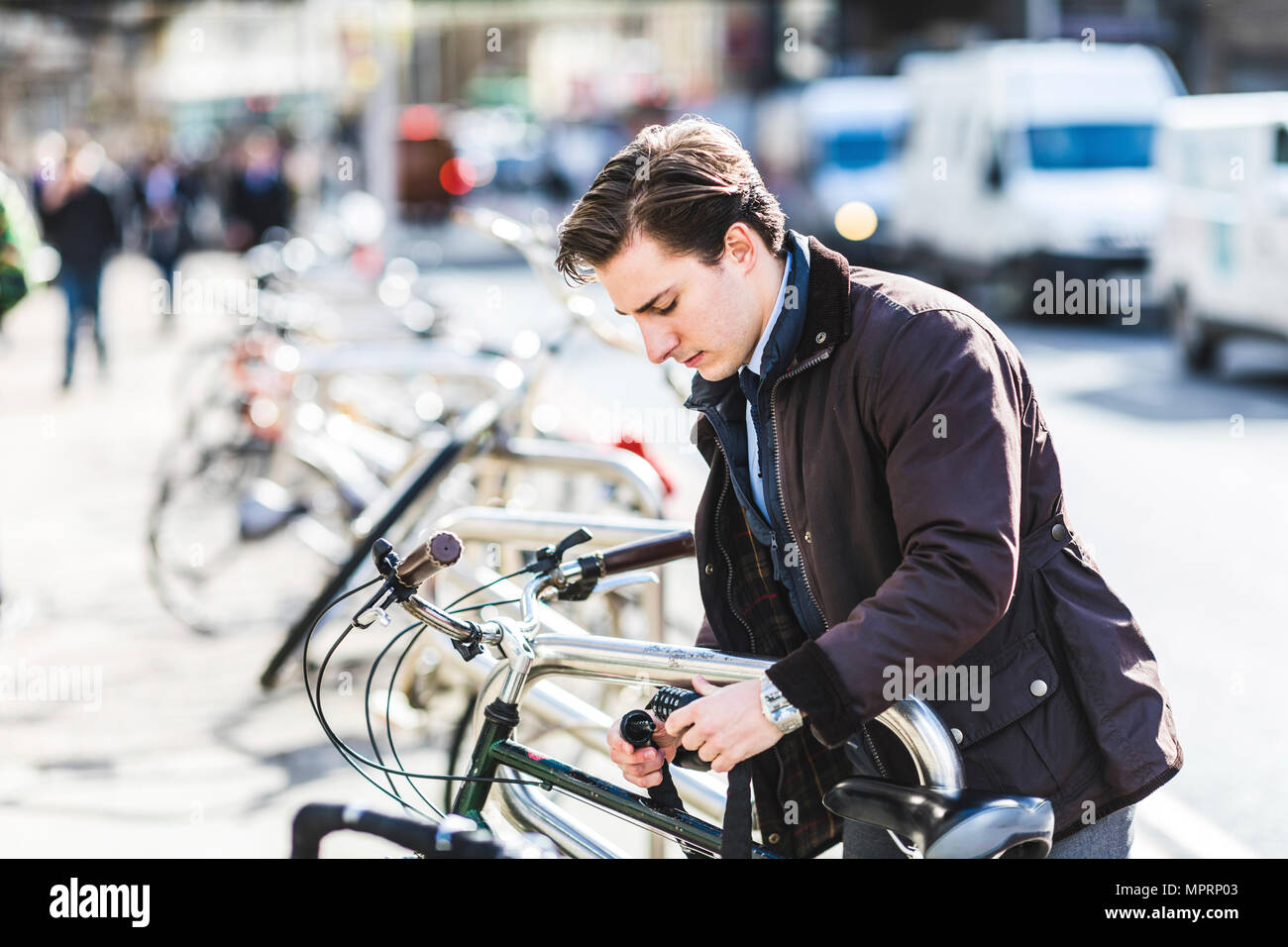 Businessman locking bicycle city hi-res stock photography and images ...