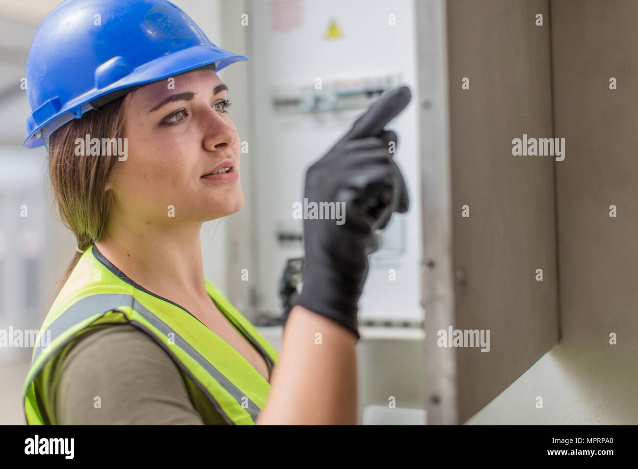 Young female electrician working fusebox hi-res stock photography and ...