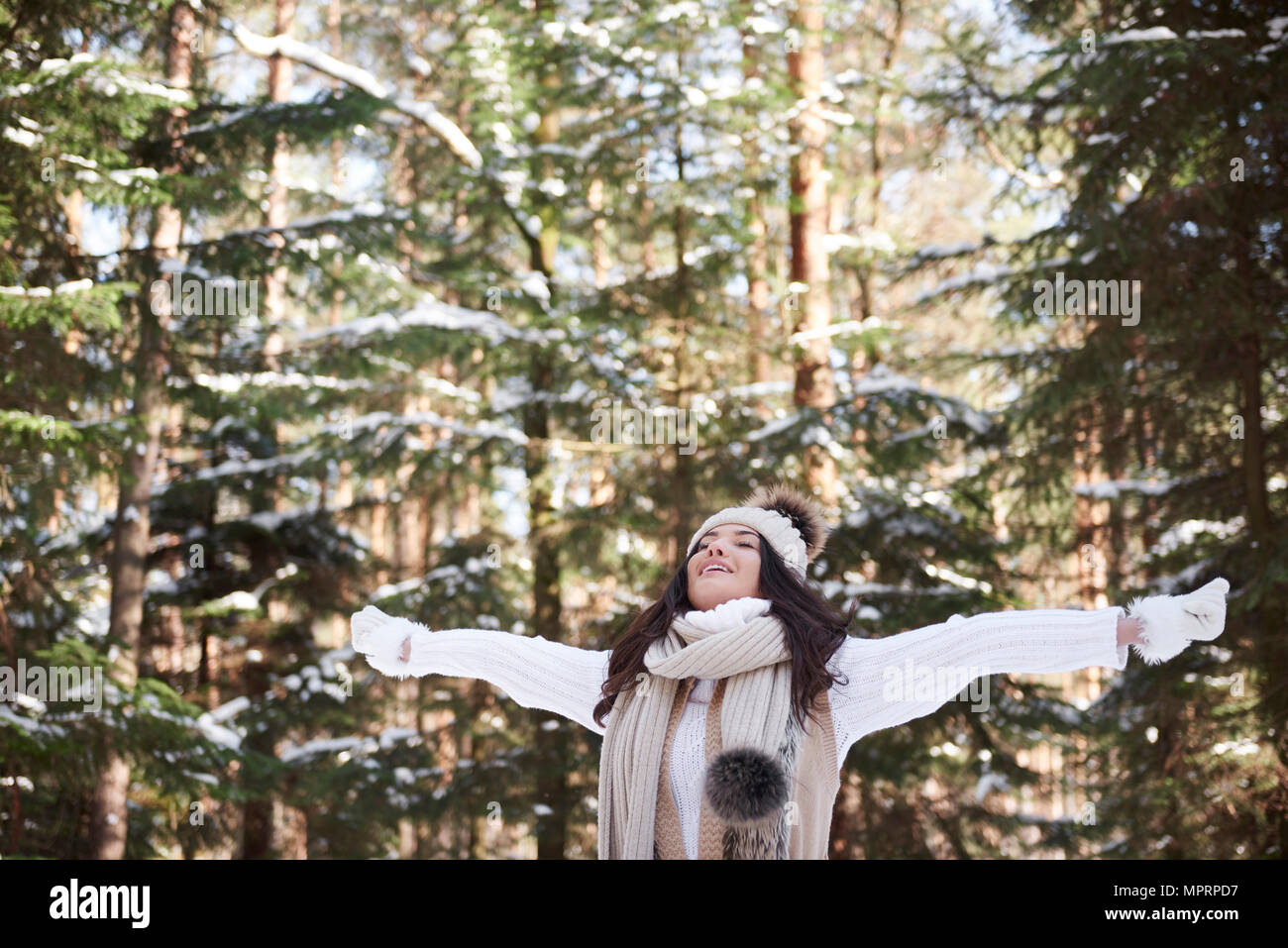 Young woman relaxing in winter forest Stock Photo - Alamy