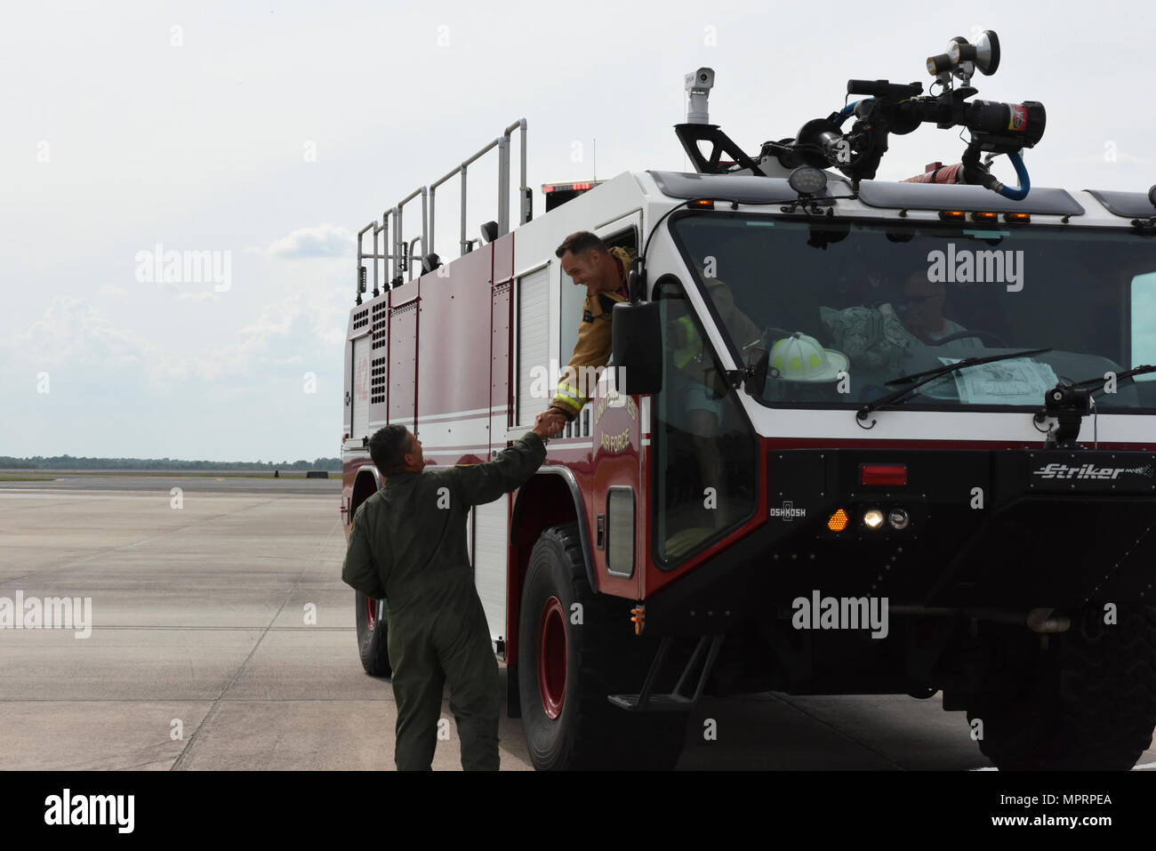 U.S. Air Force Maj. Gen. D. Todd Kelly shakes hands with firefighters ...