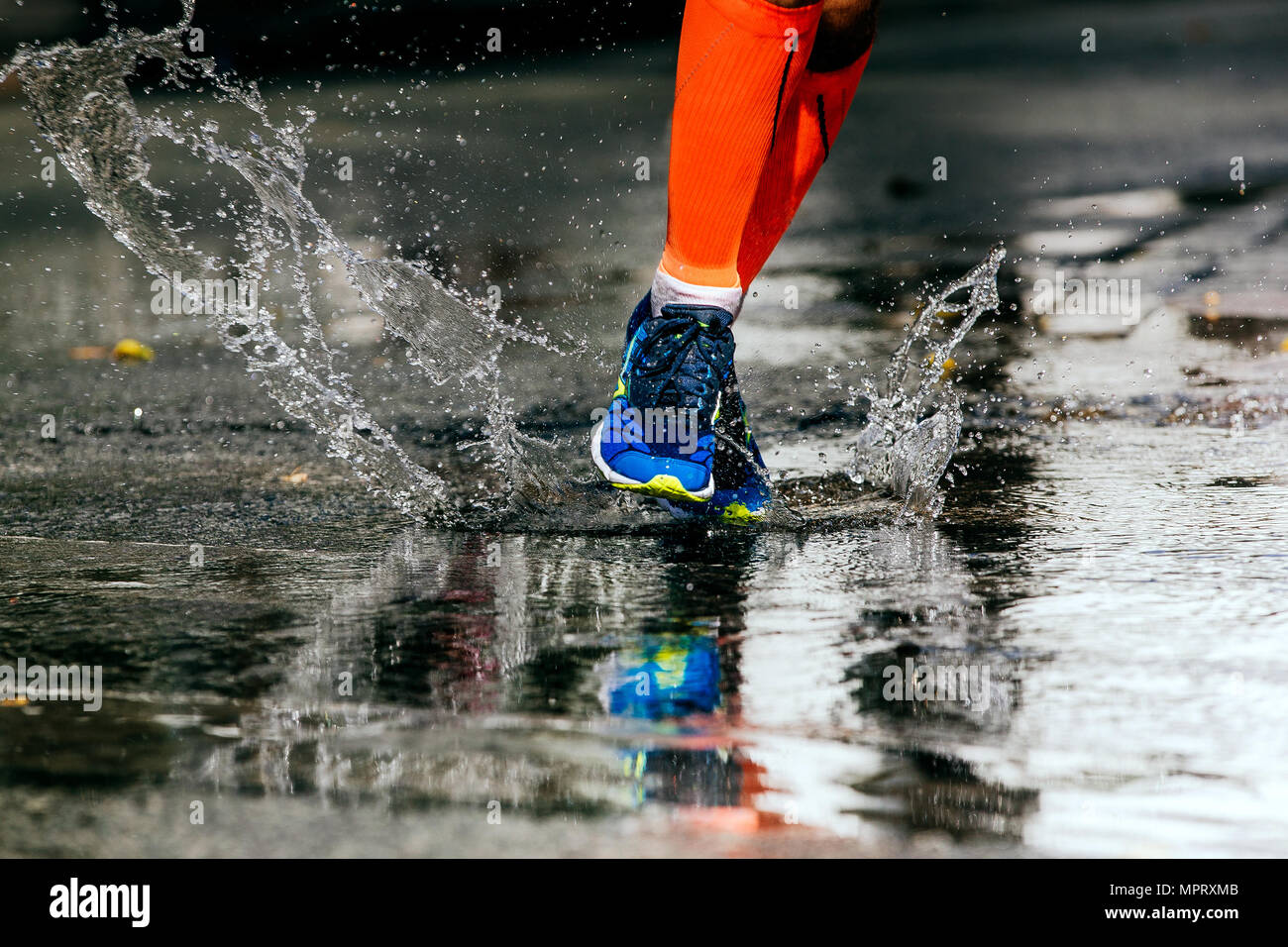 athlete runner run on puddle splashes and drops of water Stock Photo ...