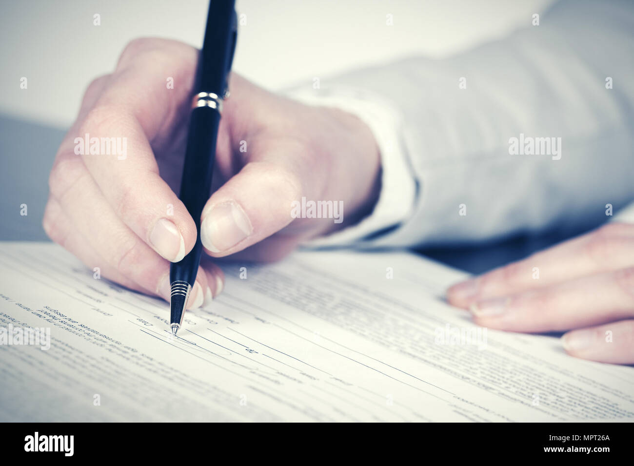 Business woman signing contract Stock Photo - Alamy