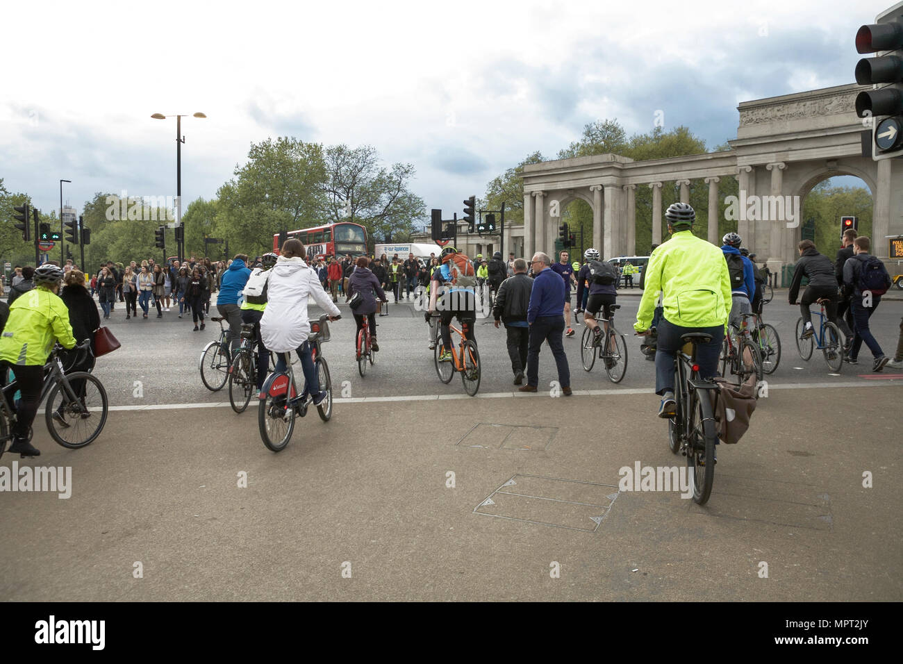 Hyde Park Corner London cyclists and pedestrians crossing a road ...