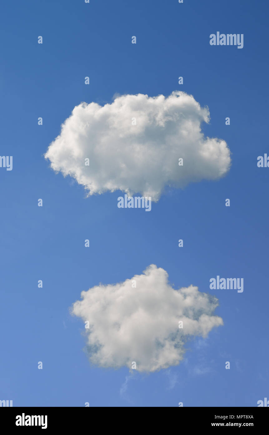 Two clouds one above the other in the blue sky Stock Photo - Alamy