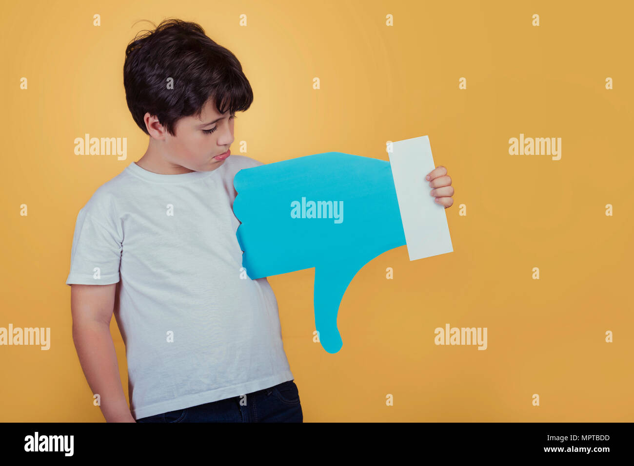 sad boy with a big dislike on yellow background sad boy with a big ...