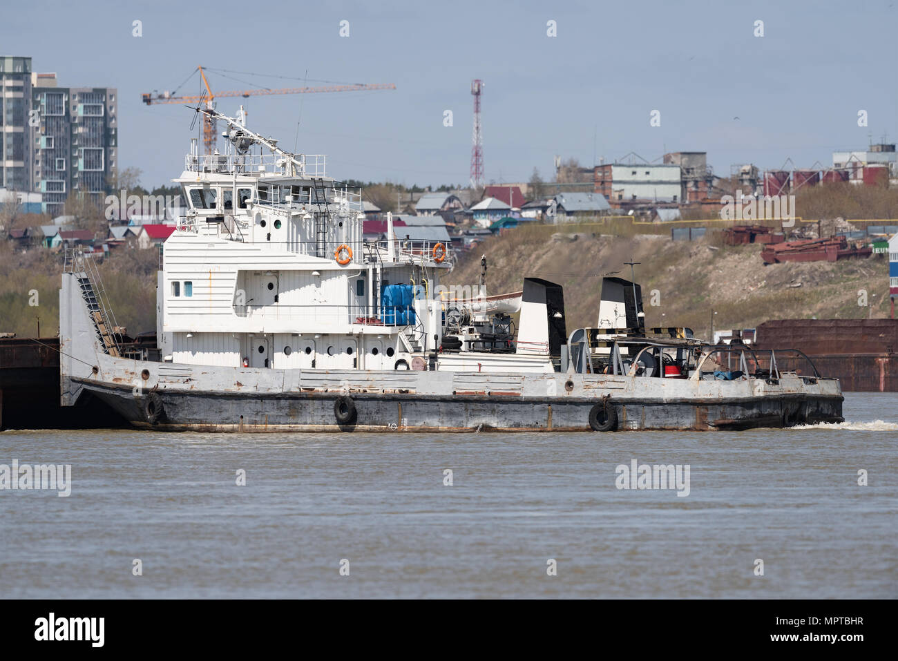 The tug carries a barge with sand Stock Photo - Alamy