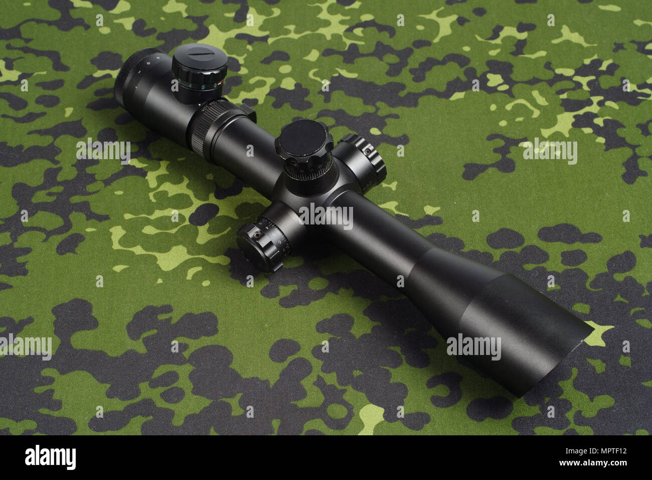 sniper scope on camouflage background Stock Photo - Alamy