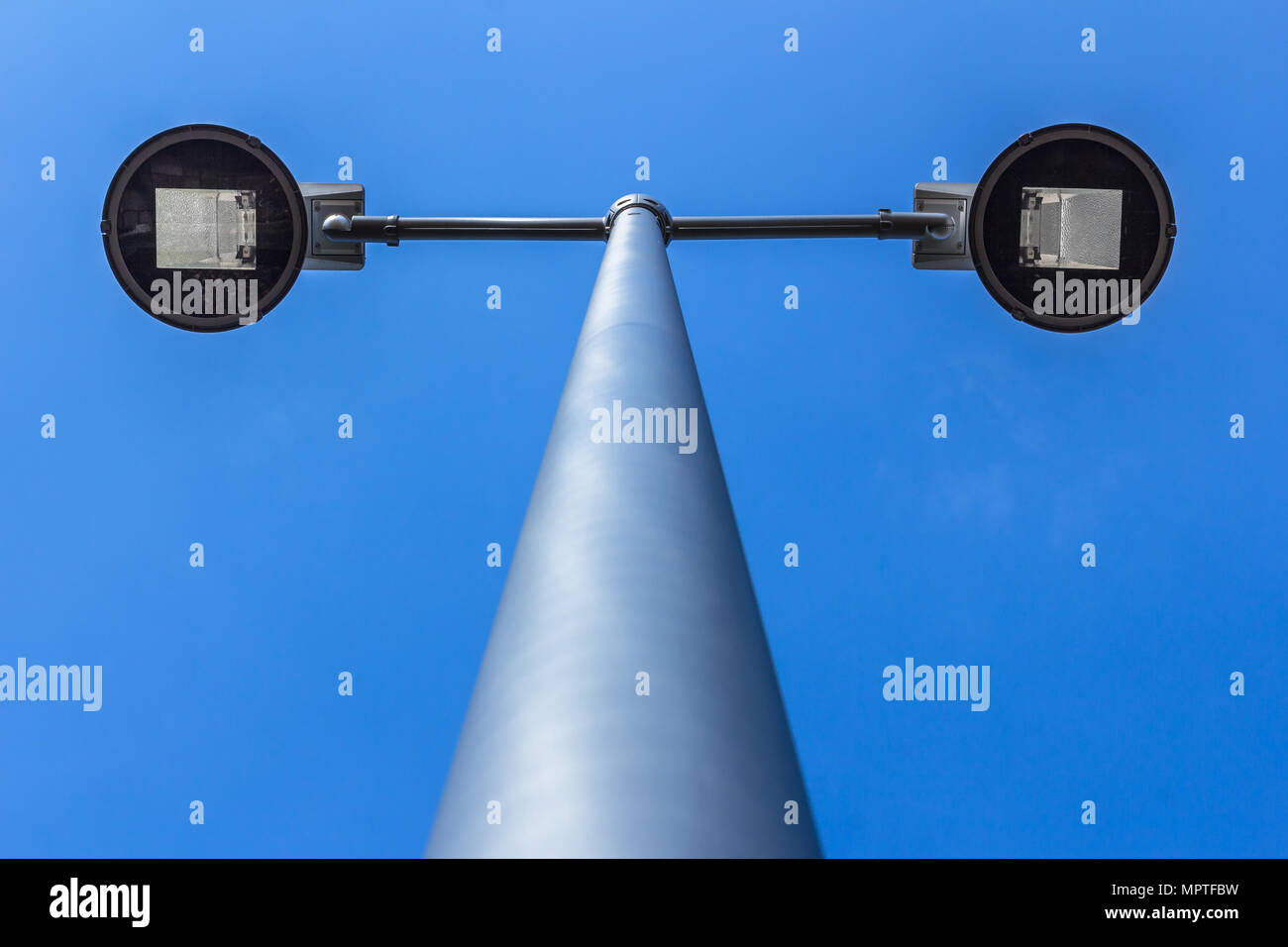Modern electric street light pole over blue sky with clouds. Bottom ...